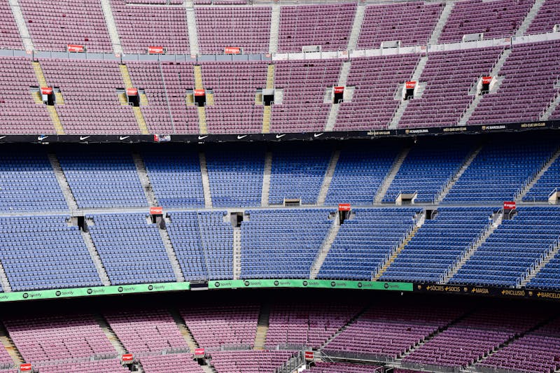 Panoramic view of empty Camp Nou seats in Barcelona showing blue and purple colored sections