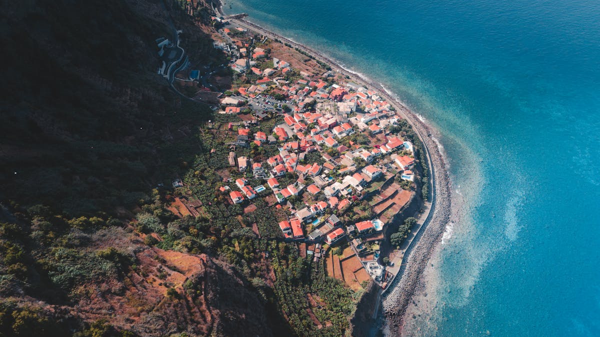 Aerial view of a coastal village in Madeira Portugal with blue ocean