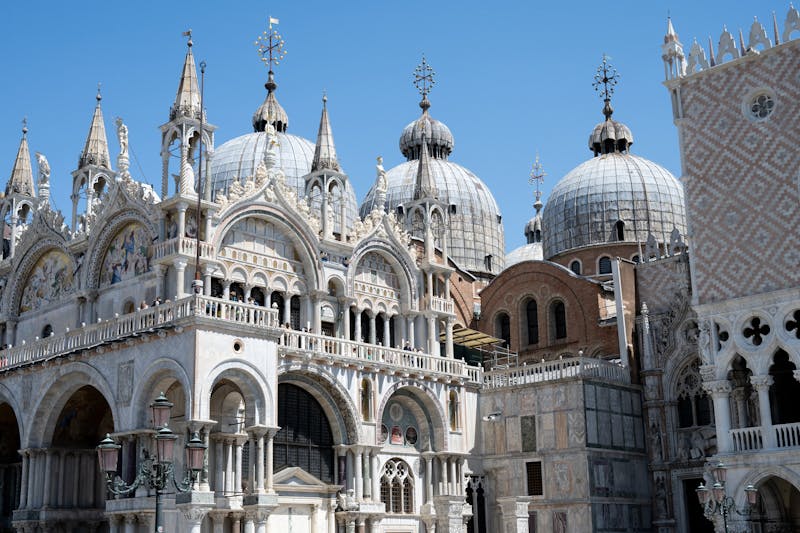 The domes and ornate facade of St Marks Basilica in Venice Italy