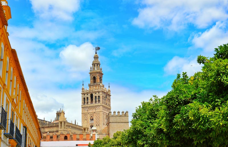 La Giralda bell tower of Seville Cathedral against a clear blue sky in Spain