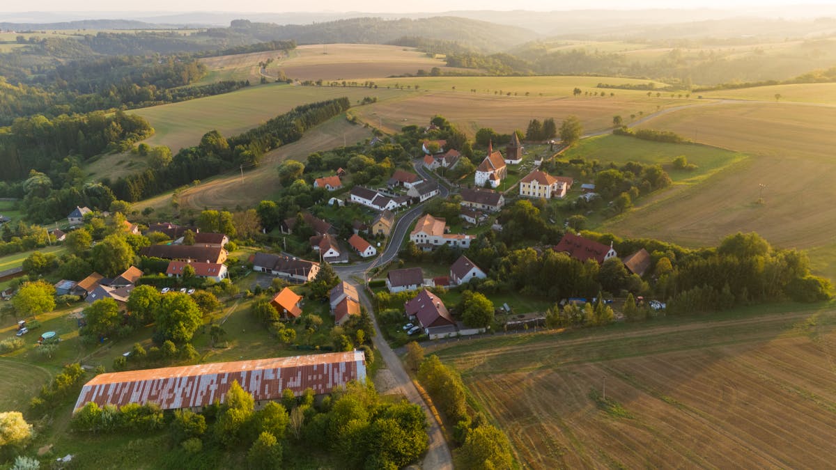 Drone photograph of a Czech village surrounded by farmland and forests
