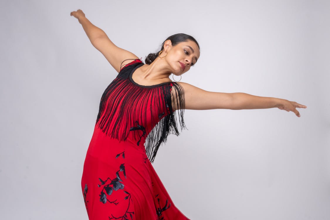 A flamenco performer in a flowing red dress during a passionate dance