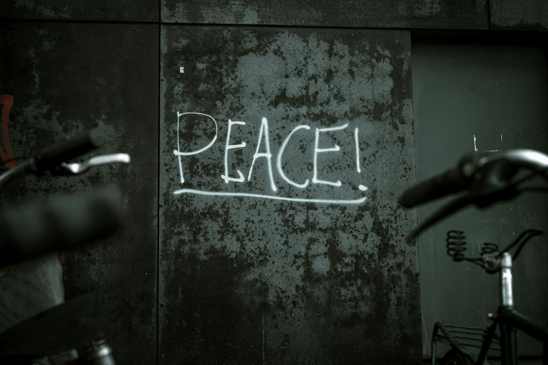 Peace graffiti on Berlin wall with bicycles