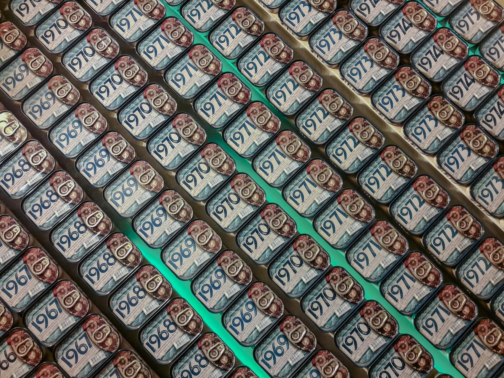 Rows of vintage sardine cans on display in a traditional Porto food shop