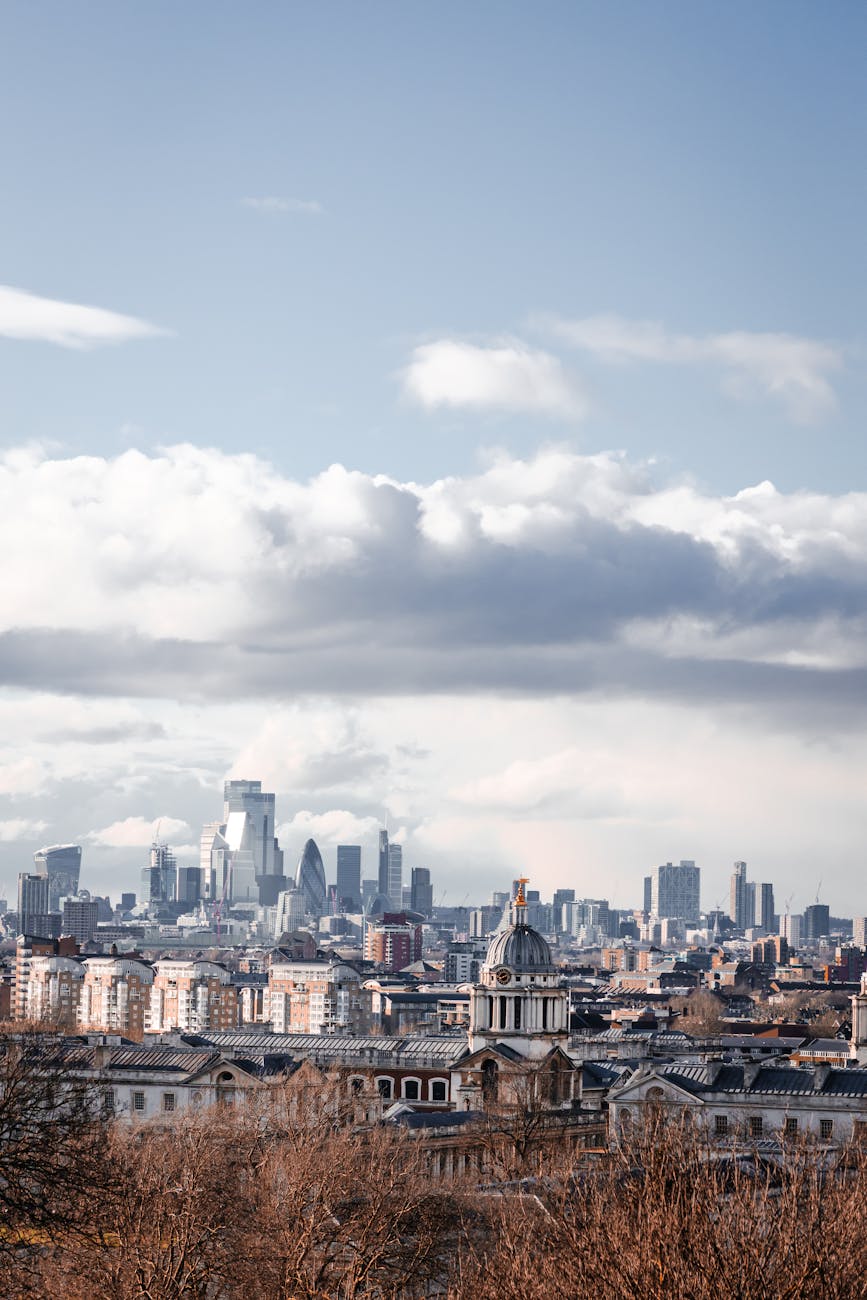 Panoramic view of the London skyline including skyscrapers seen from Greenwich with the river in the foreground