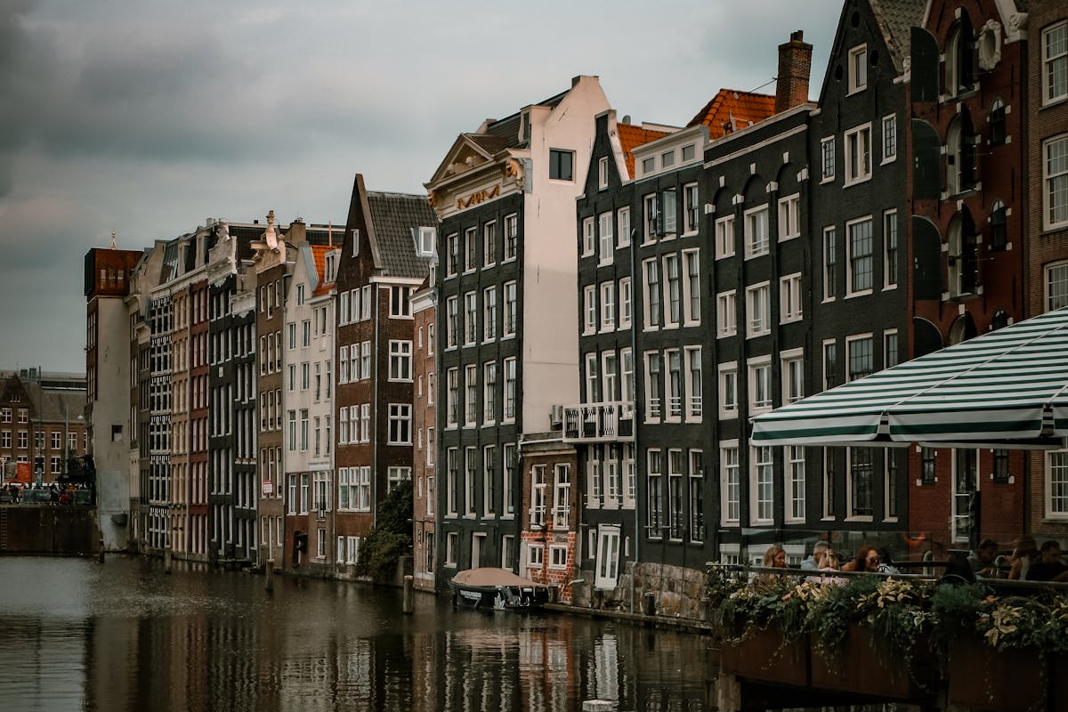 A row of traditional Amsterdam canal houses photographed with warm vintage tones