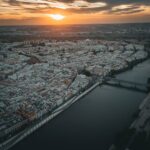 Aerial view of Seville Spain at sunset showing the city skyline and Guadalquivir River
