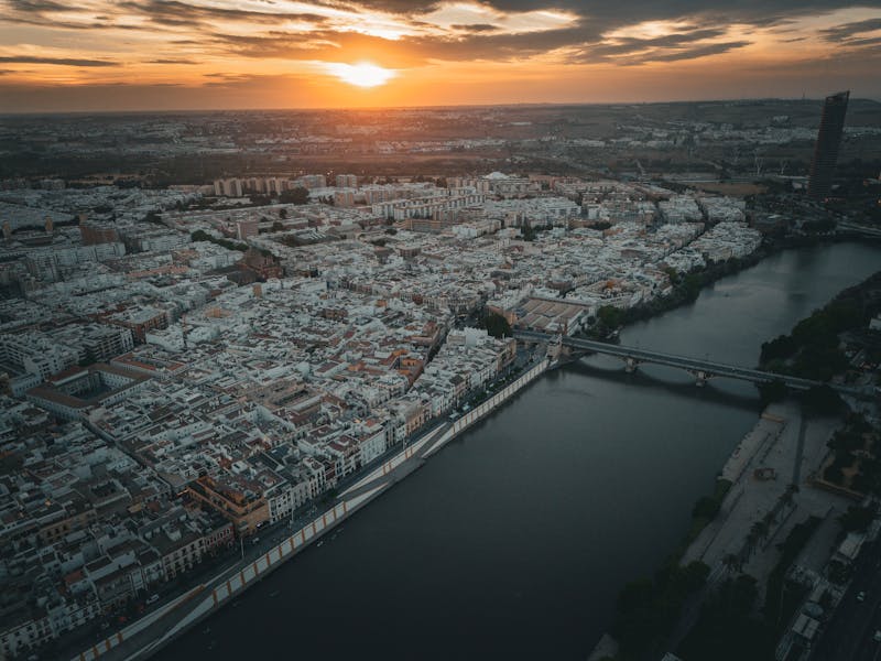 Aerial view of Seville Spain at sunset showing the city skyline and Guadalquivir River