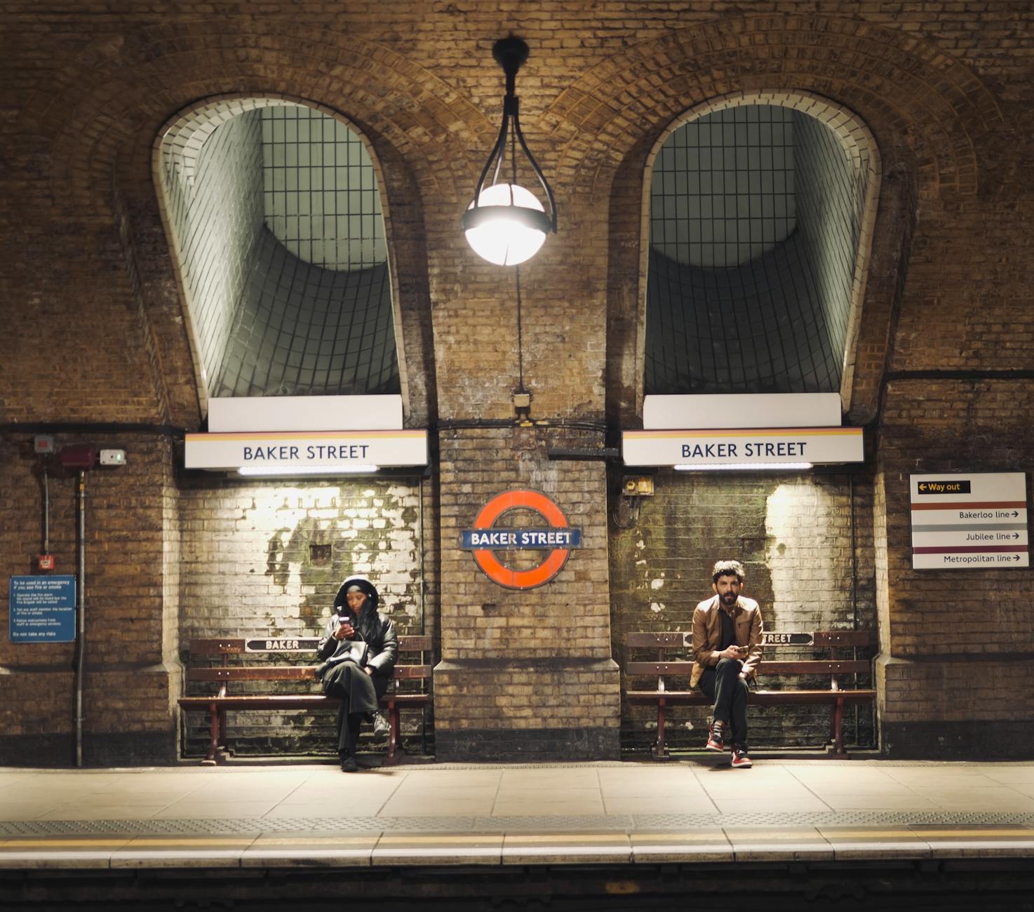 Two passengers at historic Baker Street London Underground station