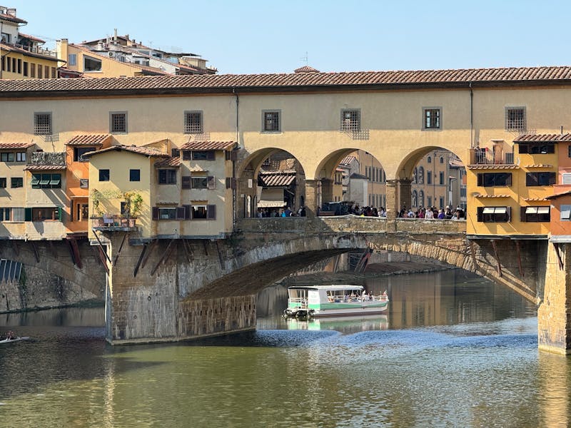 The historic Ponte Vecchio bridge spanning the Arno River in Florence Italy