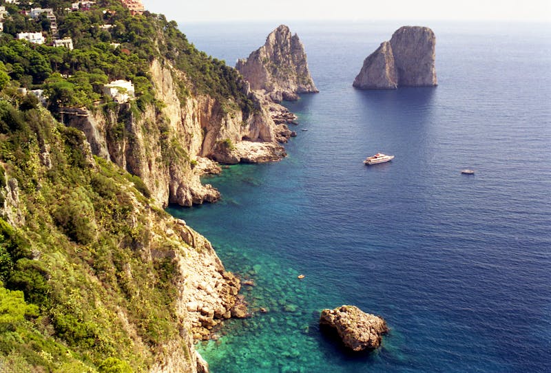 Breathtaking view of the white limestone cliffs and deep blue sea at the Isle of Capri Italy