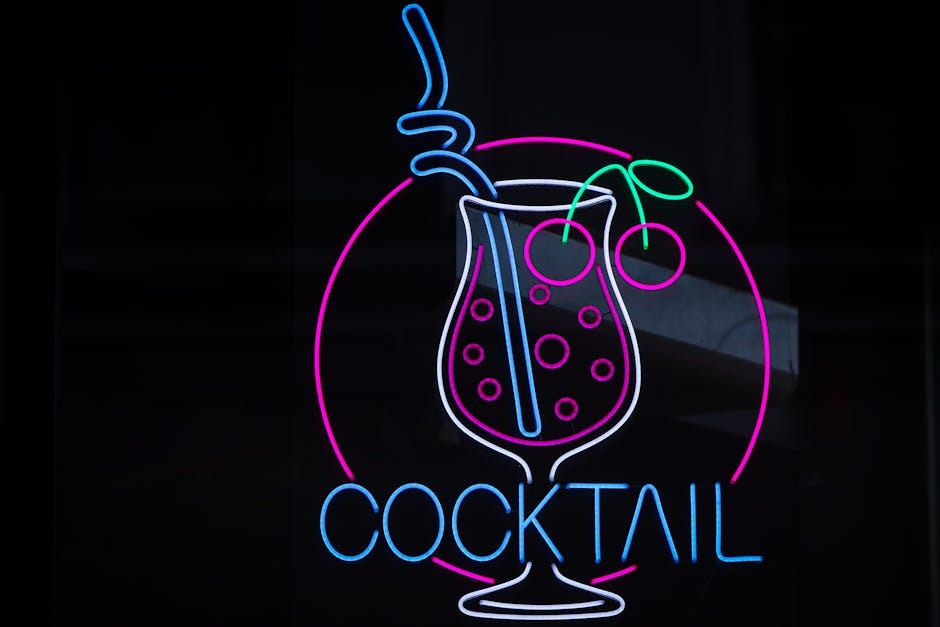 Colorful neon cocktail sign glowing on a dark background