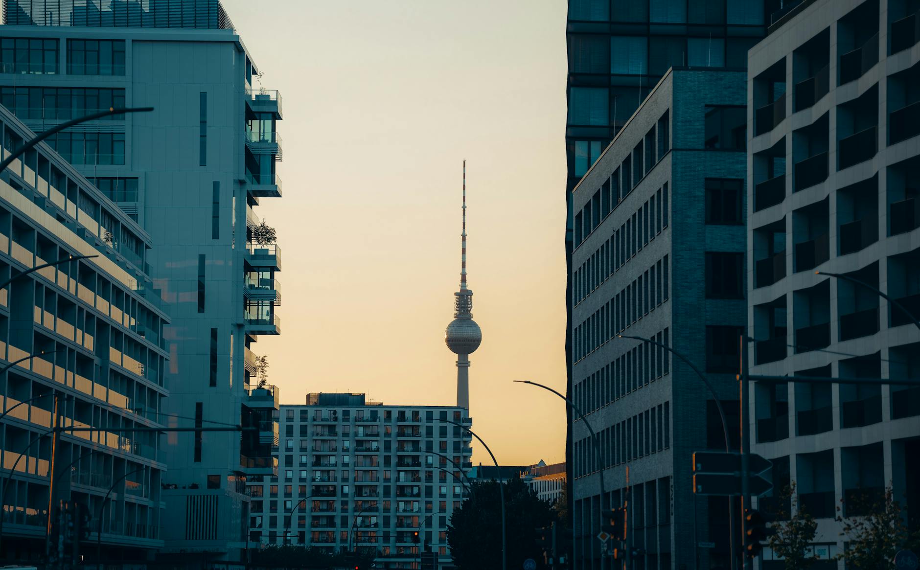 Berlin TV Tower between modern buildings at sunset