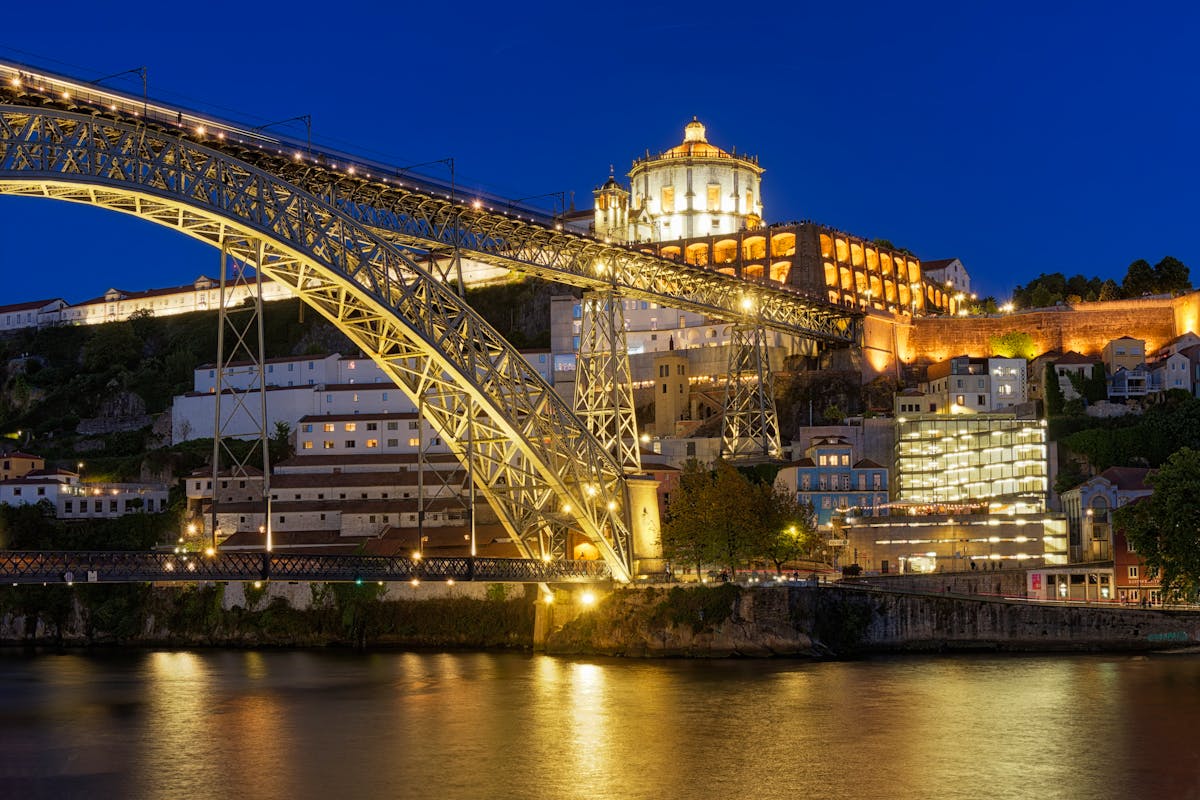 The Dom Luis I Bridge and Serra do Pilar Monastery lit up at night in Porto