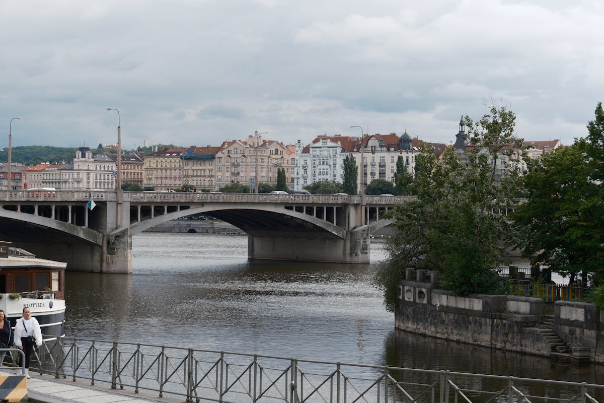 Scenic view of the Vltava River and Prague historic architecture from a riverside perspective