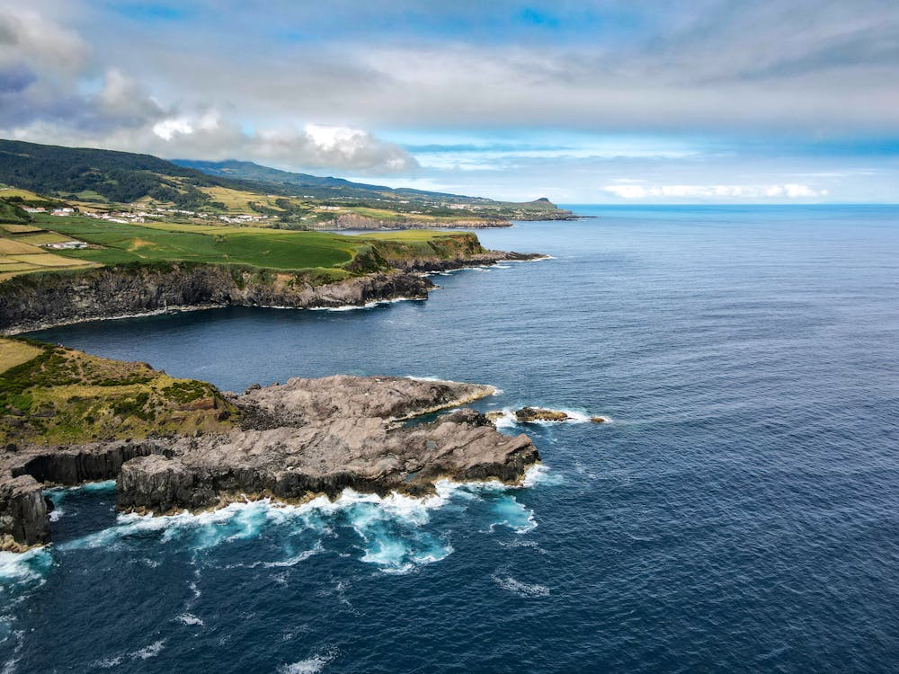 Breathtaking aerial view of coastal cliffs and ocean waves in the Azores