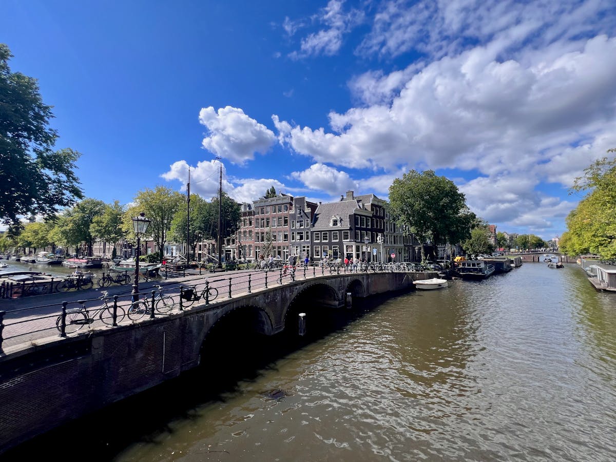 Wide panoramic view of Amsterdam canals with historic buildings
