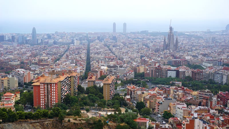 Aerial view of Barcelona cityscape featuring Sagrada Familia and the waterfront
