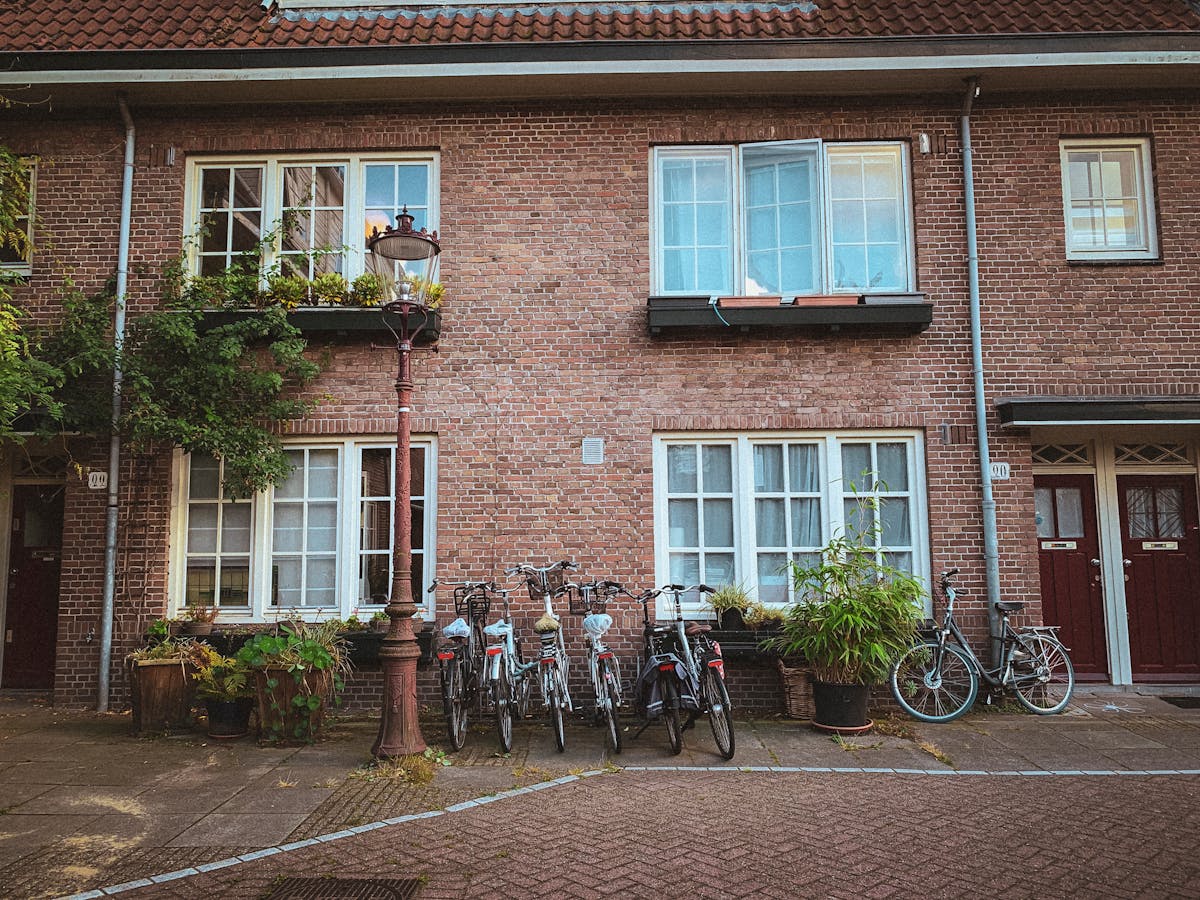 A typical Amsterdam street scene with traditional Dutch houses and bicycles parked along the sidewalk