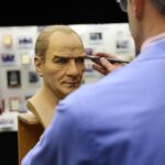 Artist meticulously paints a lifelike wax bust