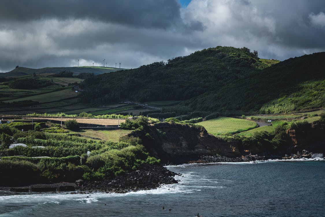 Breathtaking Azores coastline with lush green hills and dramatic sky