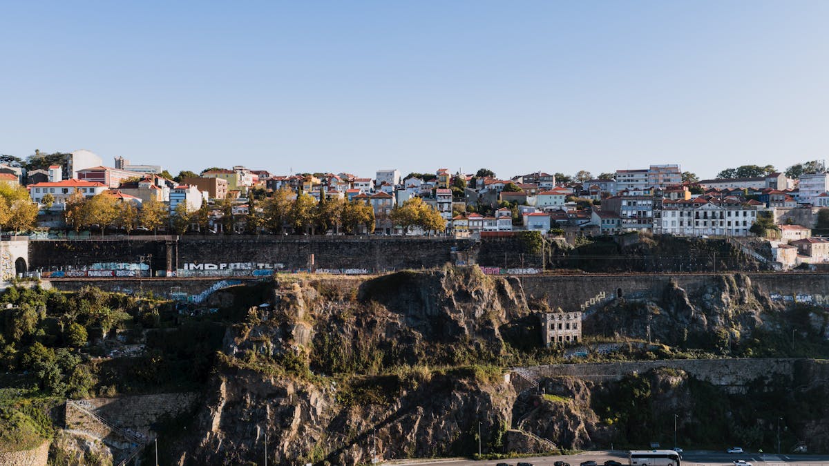 Aerial photograph showing the Porto riverside cliffs with colorful buildings stacked above the Douro River