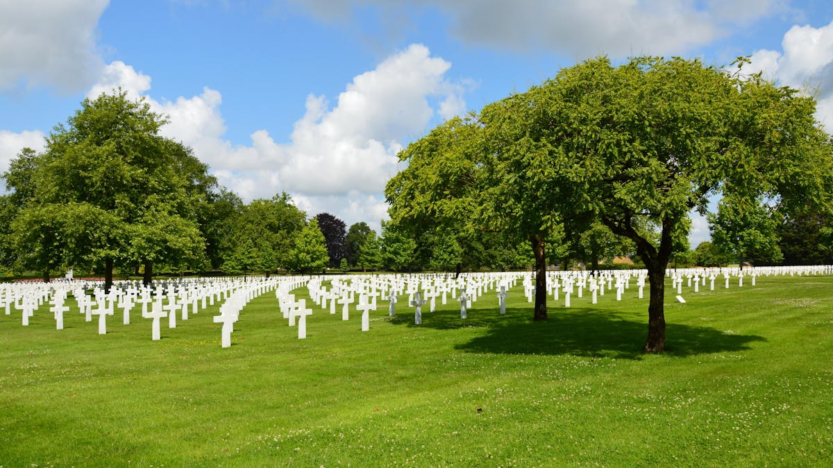 Close view of white crosses at the Normandy American Cemetery under blue skies