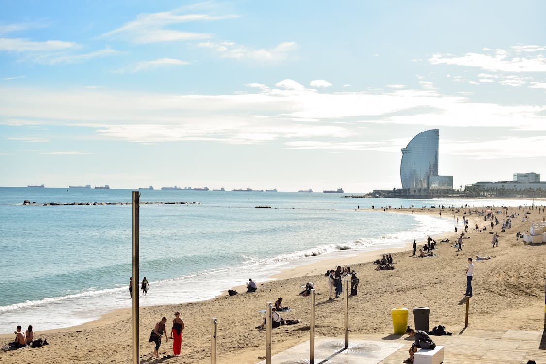 Barceloneta Beach on a sunny day with people enjoying the coastline in Barcelona
