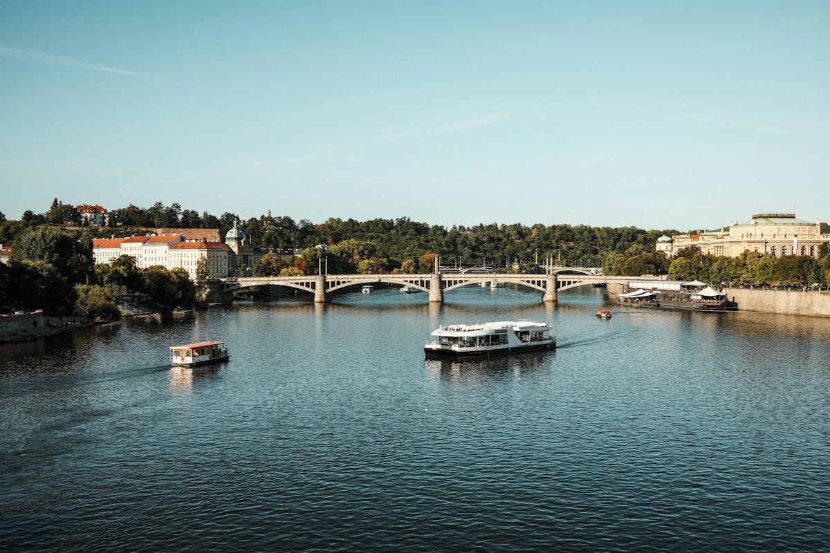 The Vltava River with boats and historic Prague architecture on both banks
