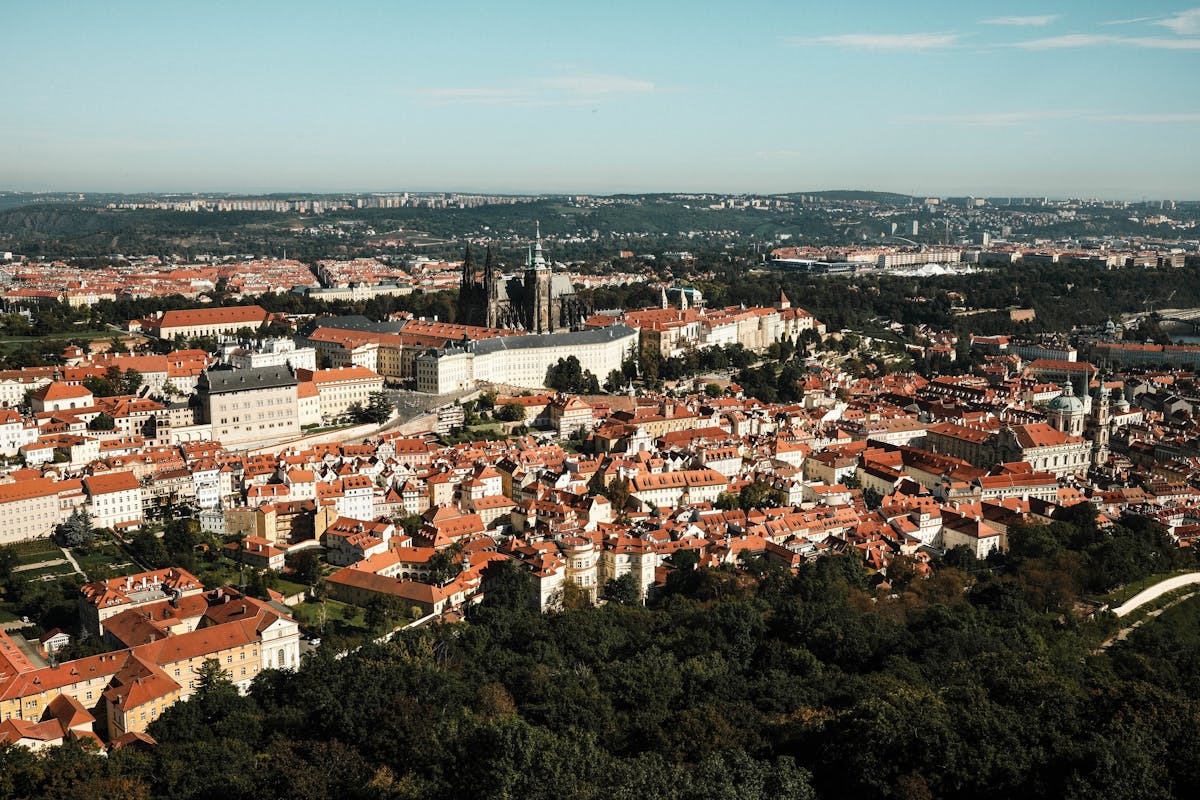 Aerial view of Prague showing red rooftops and historic architecture