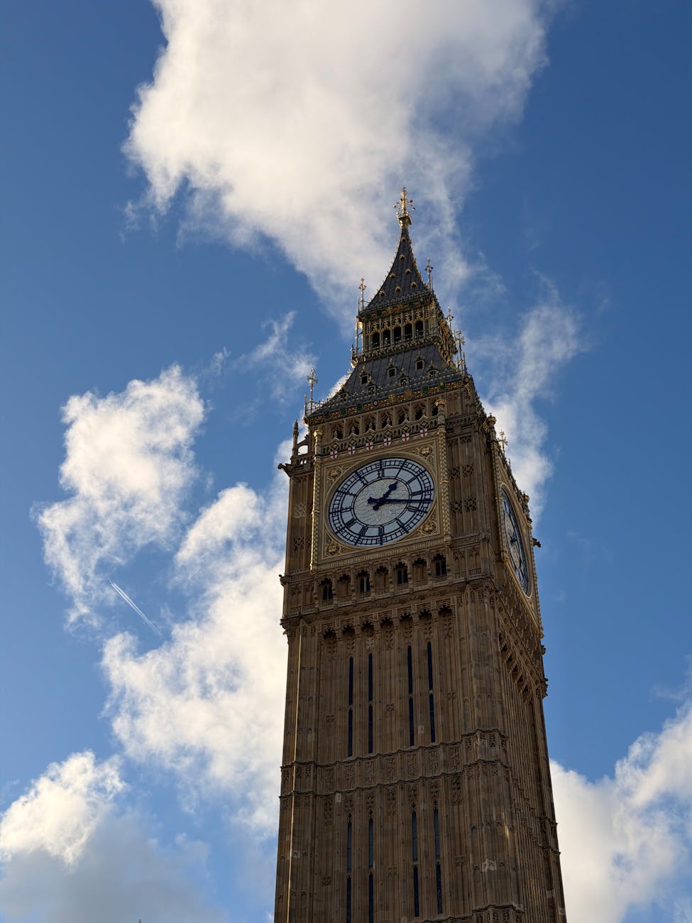 Big Ben clock tower against clouds and blue sky