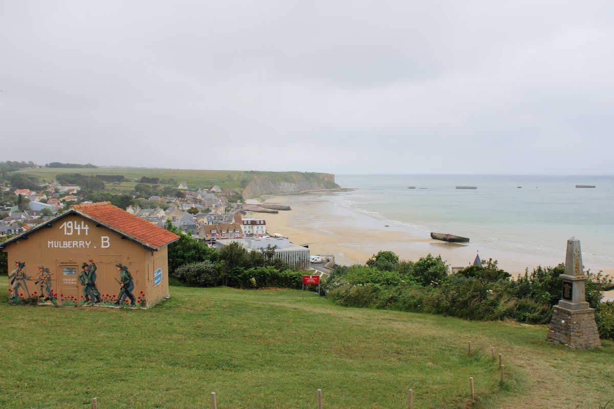 Historic Mulberry harbour remains visible along the Arromanches coastline in Normandy
