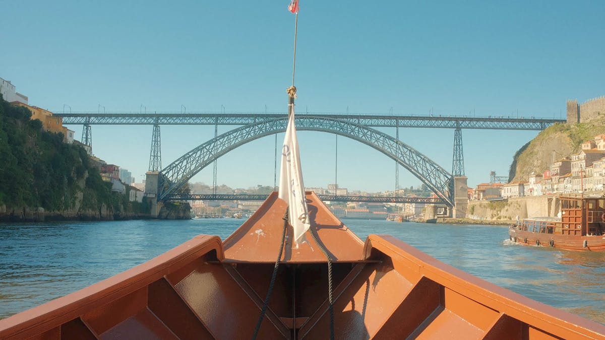 Perspective from a boat on the Douro River looking up at the Dom Luis I Bridge in Porto
