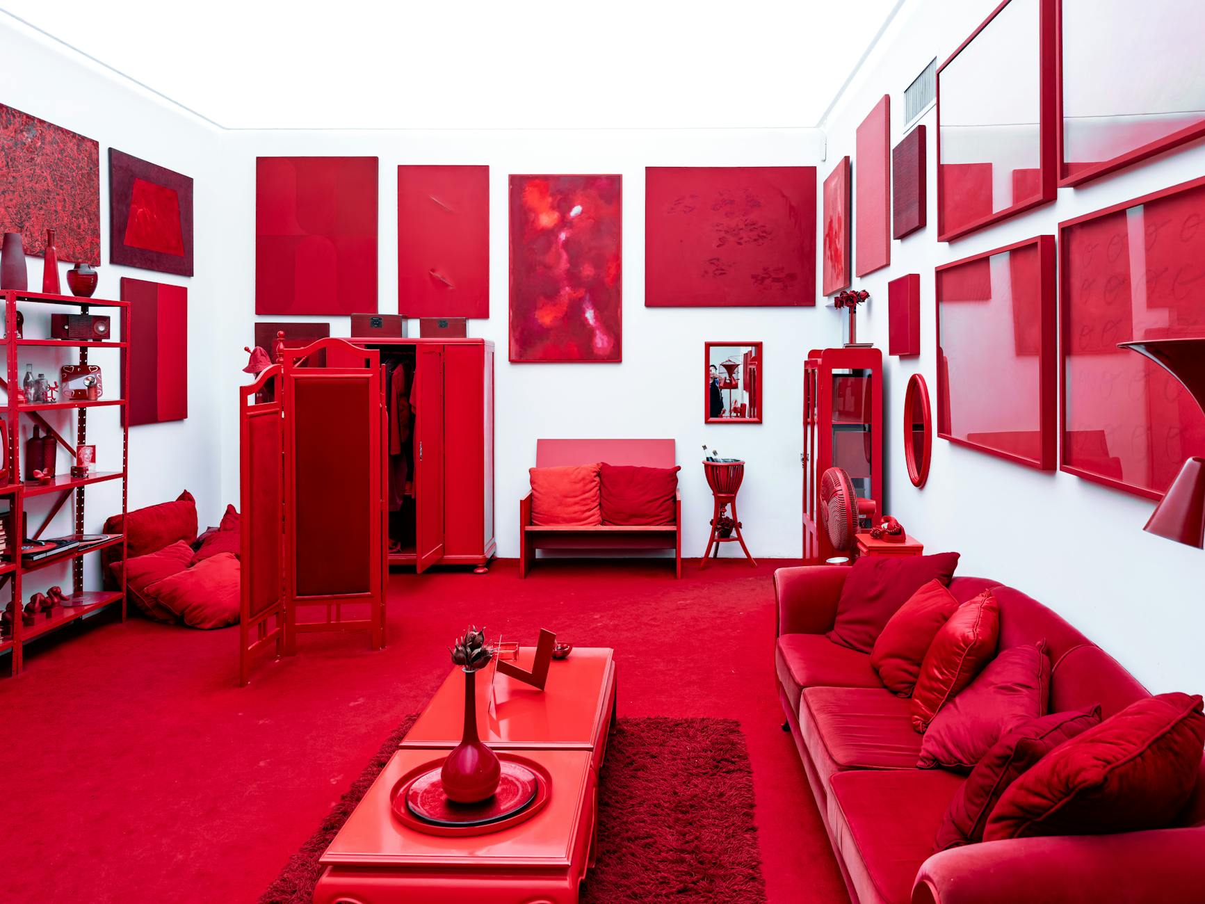 A striking red themed room with modern art pieces and furniture creating a bold visual statement