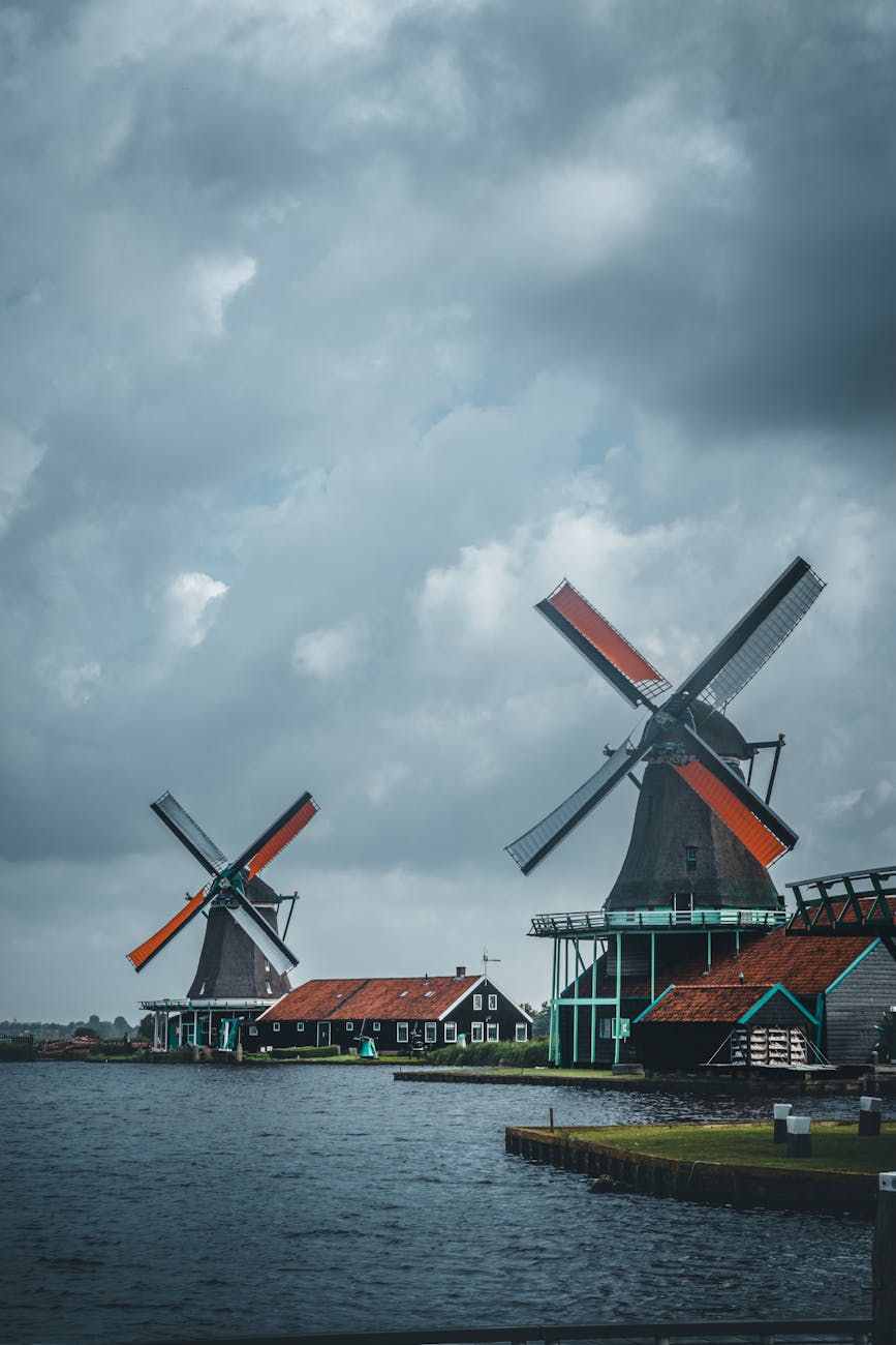 Historic windmills against a cloudy sky at Zaanse Schans in Zaandam