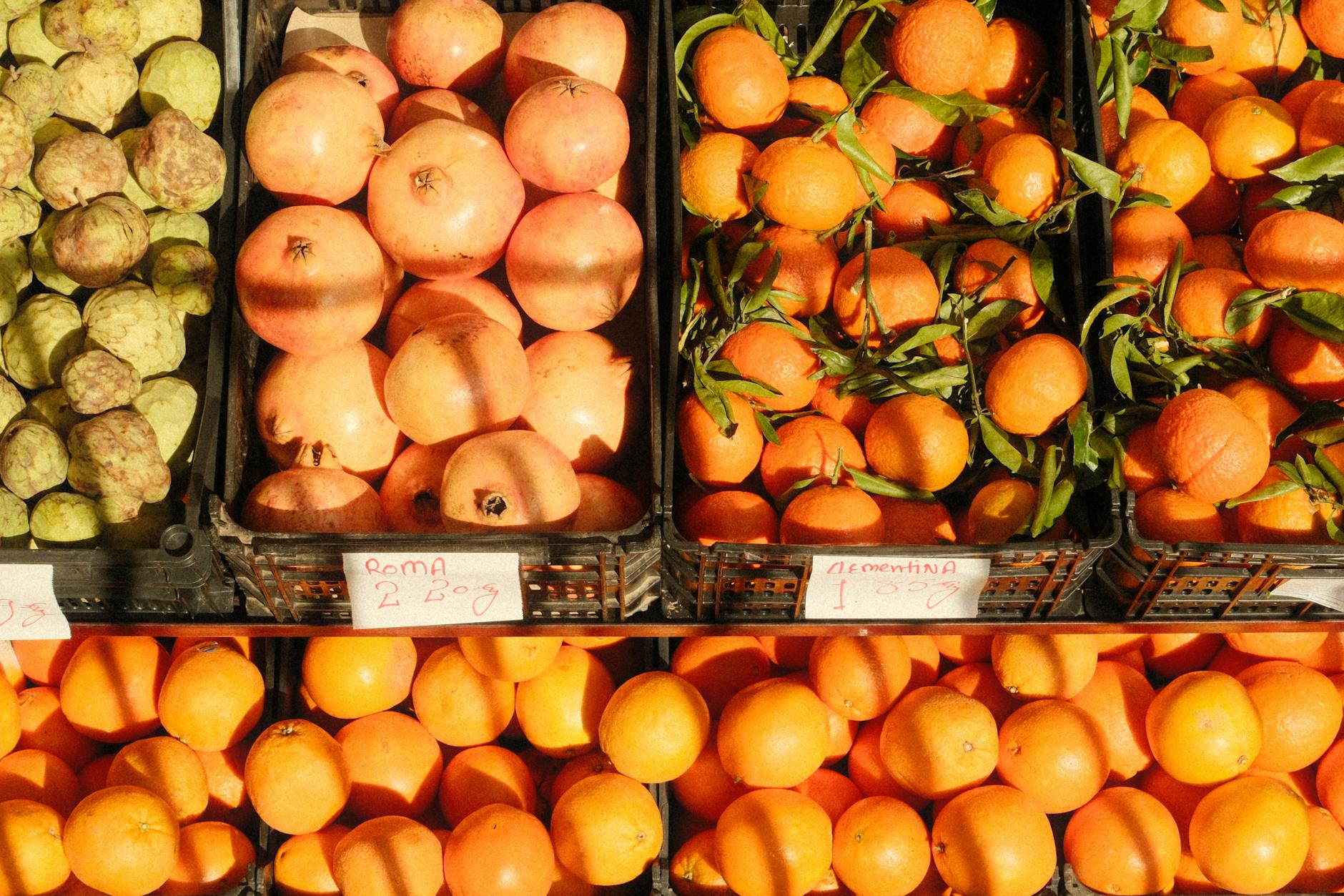 Colorful citrus fruits and pomegranates at a Lisbon market stall
