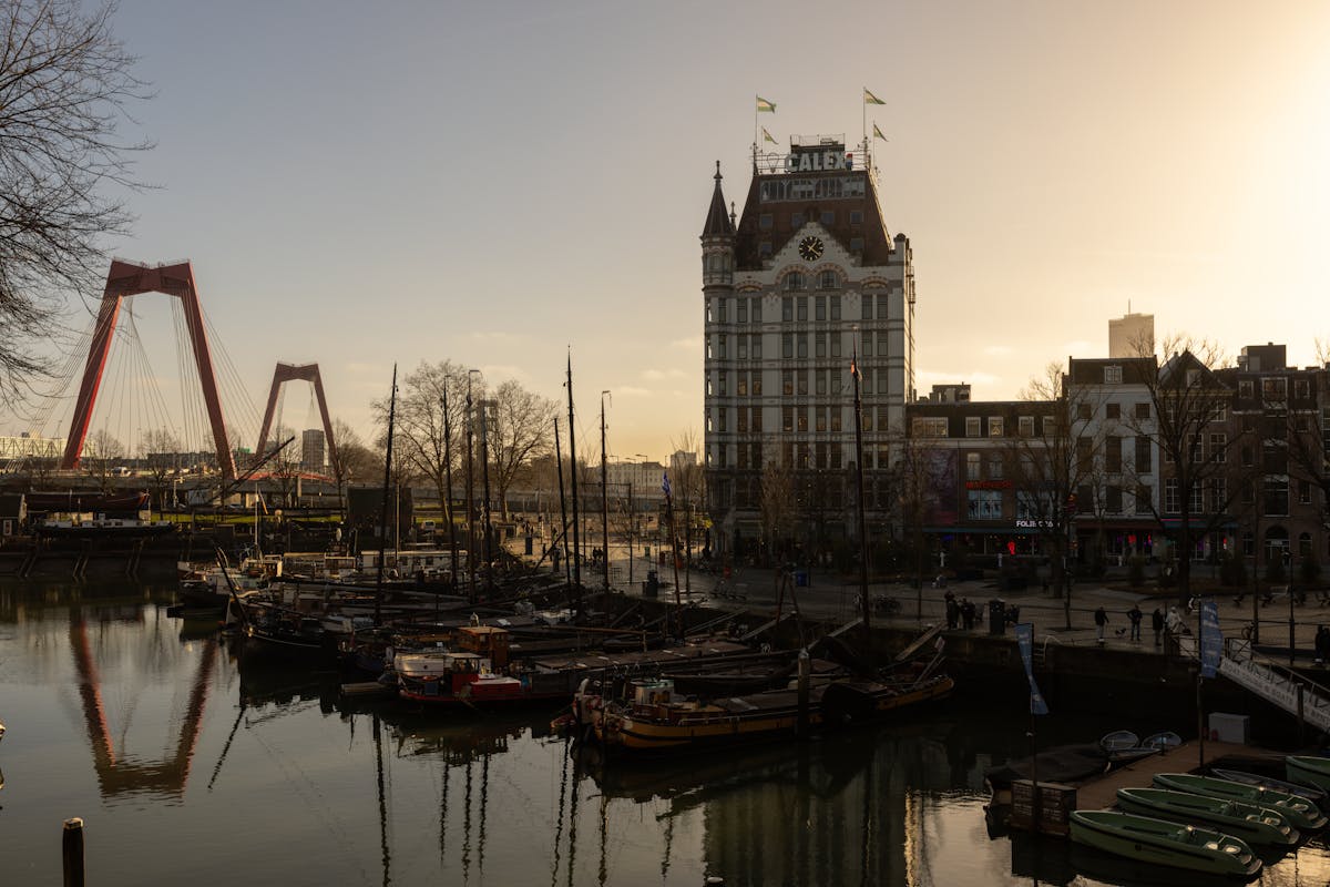 Sunset view of the Willemsbrug bridge and historic White House building in Rotterdam