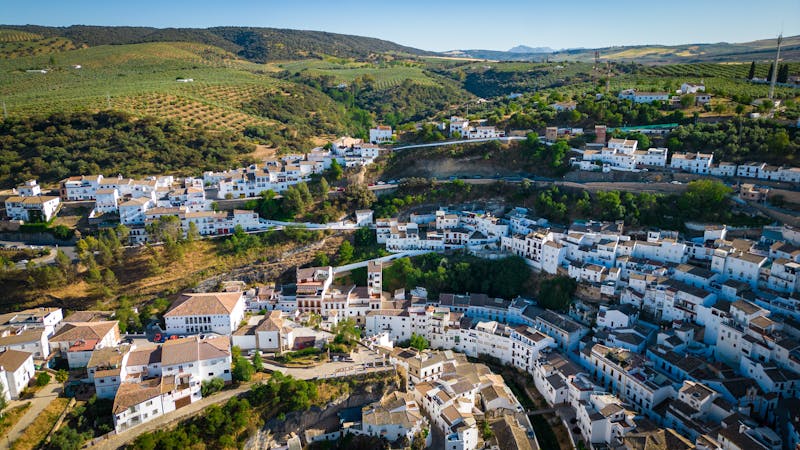 Aerial view of Setenil de las Bodegas with whitewashed houses built into cliff overhangs