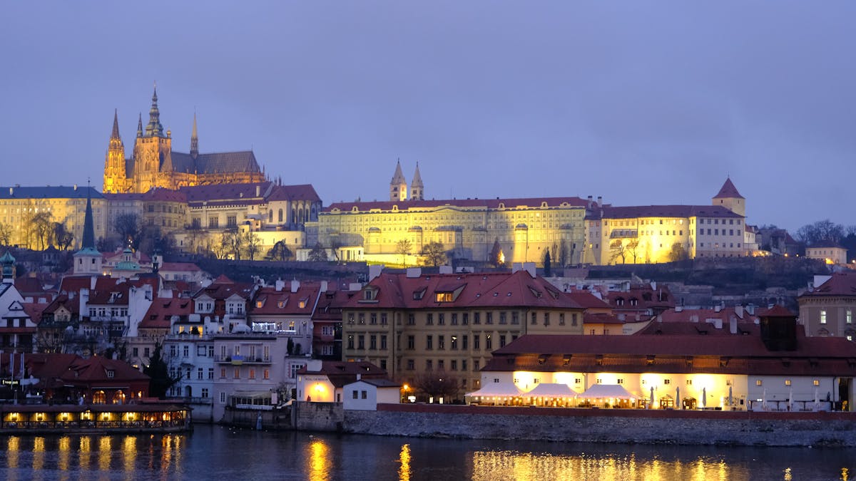 Prague Castle and surrounding historic buildings illuminated at twilight