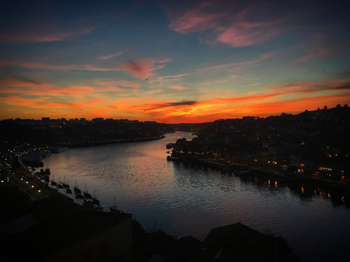 Vivid orange and purple sunset reflecting in the Douro River waters in Porto