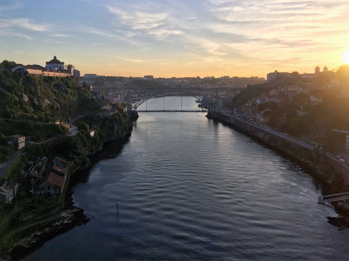 Golden light illuminating the Dom Luis I Bridge and Douro River in Porto during sunset