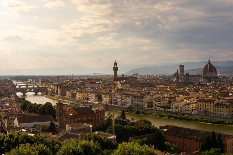 Panoramic view of Florence Italy featuring the iconic Duomo and Arno River at sunset