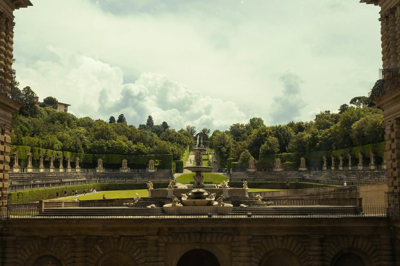 Panoramic view looking down over the Boboli Gardens from the upper level of Pitti Palace showing terraces and Florence rooftops