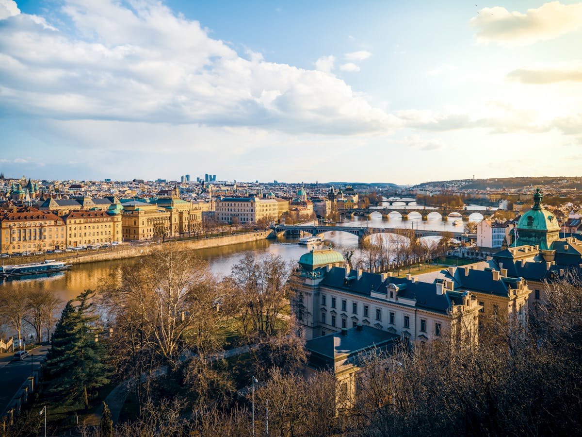 Aerial view of Prague showing bridges over the Vltava River at sunset