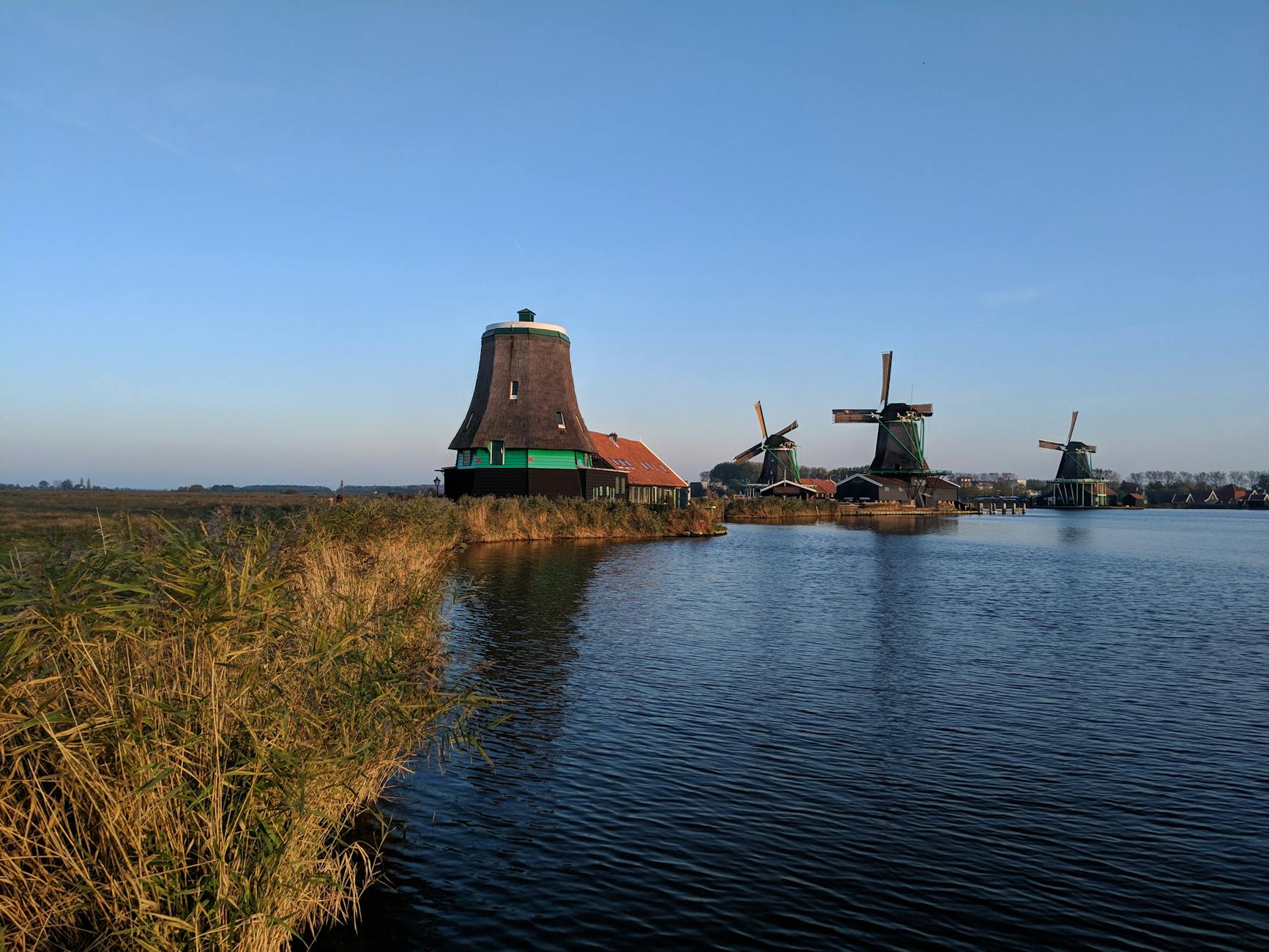 Historic windmills at Zaanse Schans in Zaandam overlooking the water