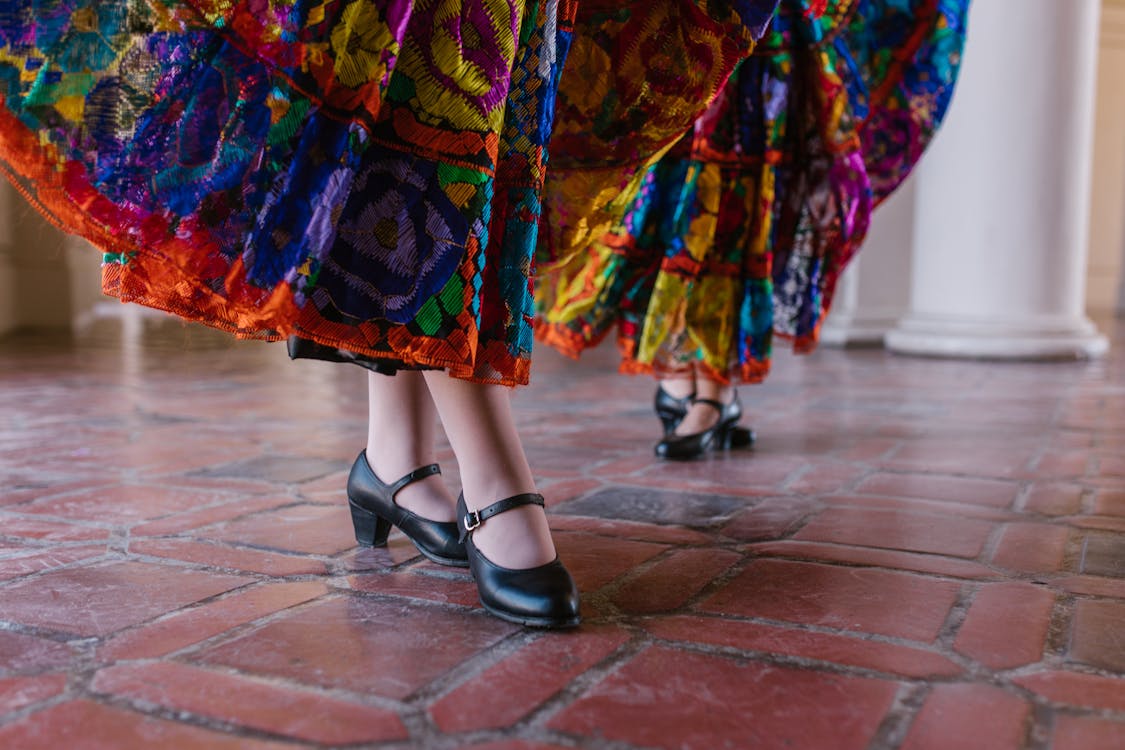 Close-up of traditional flamenco skirts and leather dance shoes during a performance
