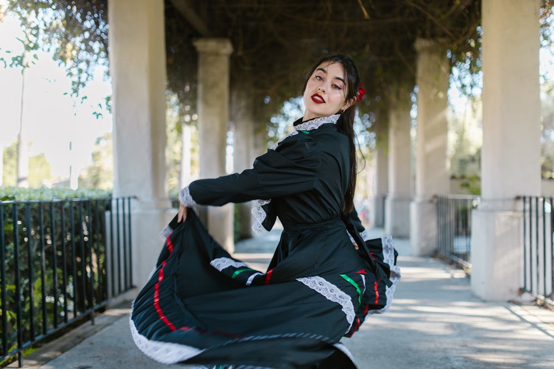 A woman dancing in a traditional black flamenco dress