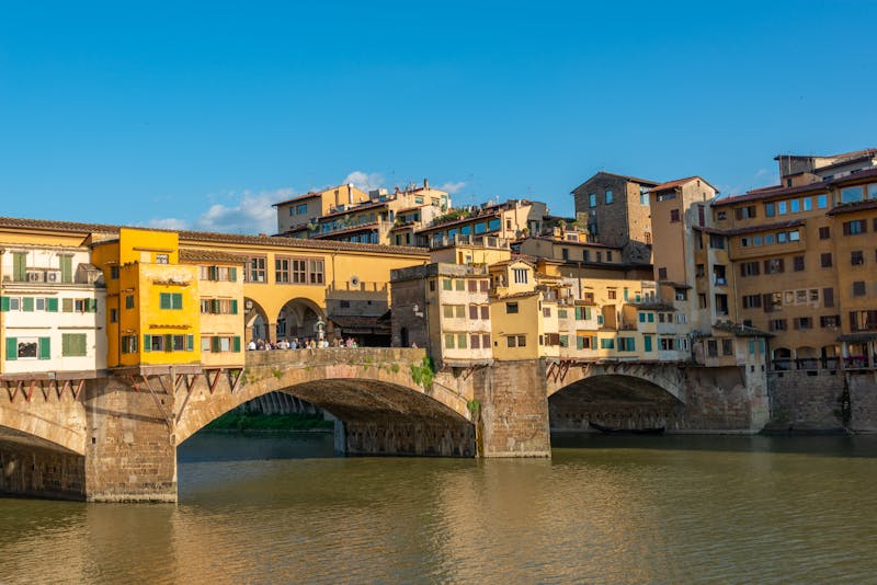 Historic Ponte Vecchio bridge viewed from along the Arno River in Florence