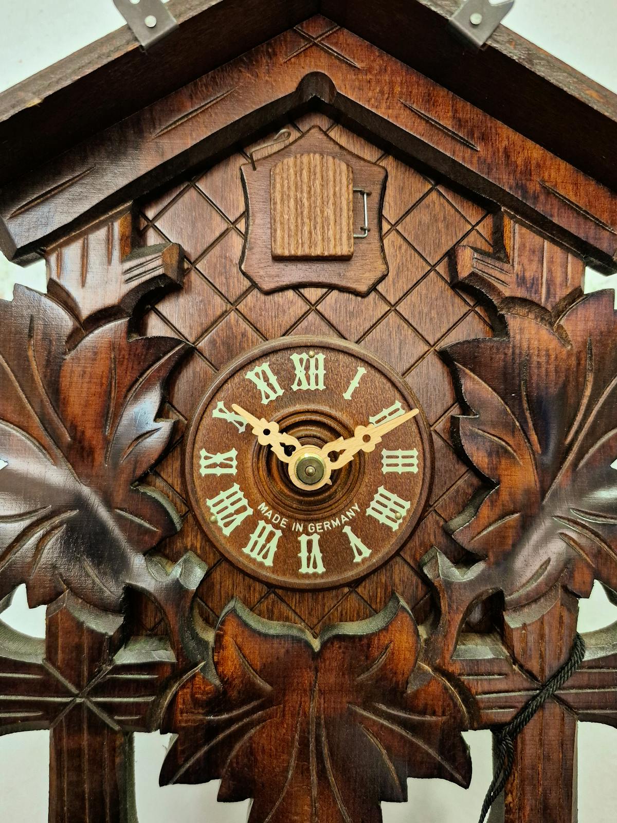 Intricately carved vintage German cuckoo clock with Roman numerals
