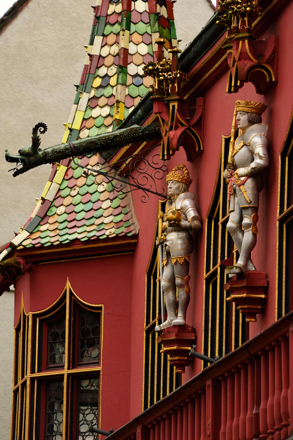 Vibrant statues and ornate tiles on Freiburg's historic building in Germany
